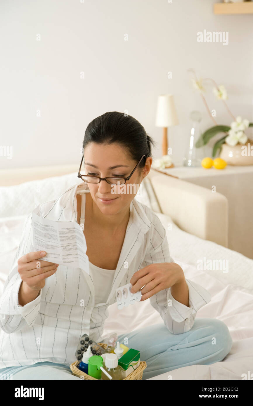 Woman reading instruction Stock Photo - Alamy