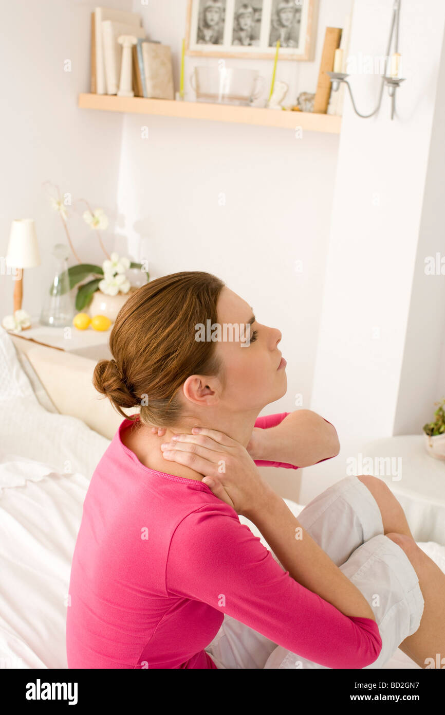 Young woman having neck pain Stock Photo - Alamy