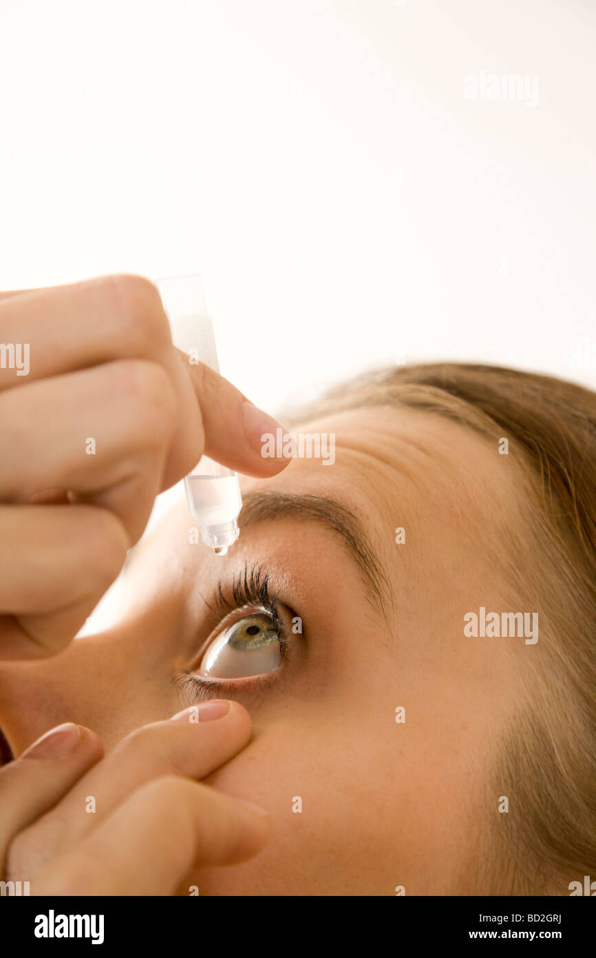 Woman applying eye drops Stock Photo - Alamy
