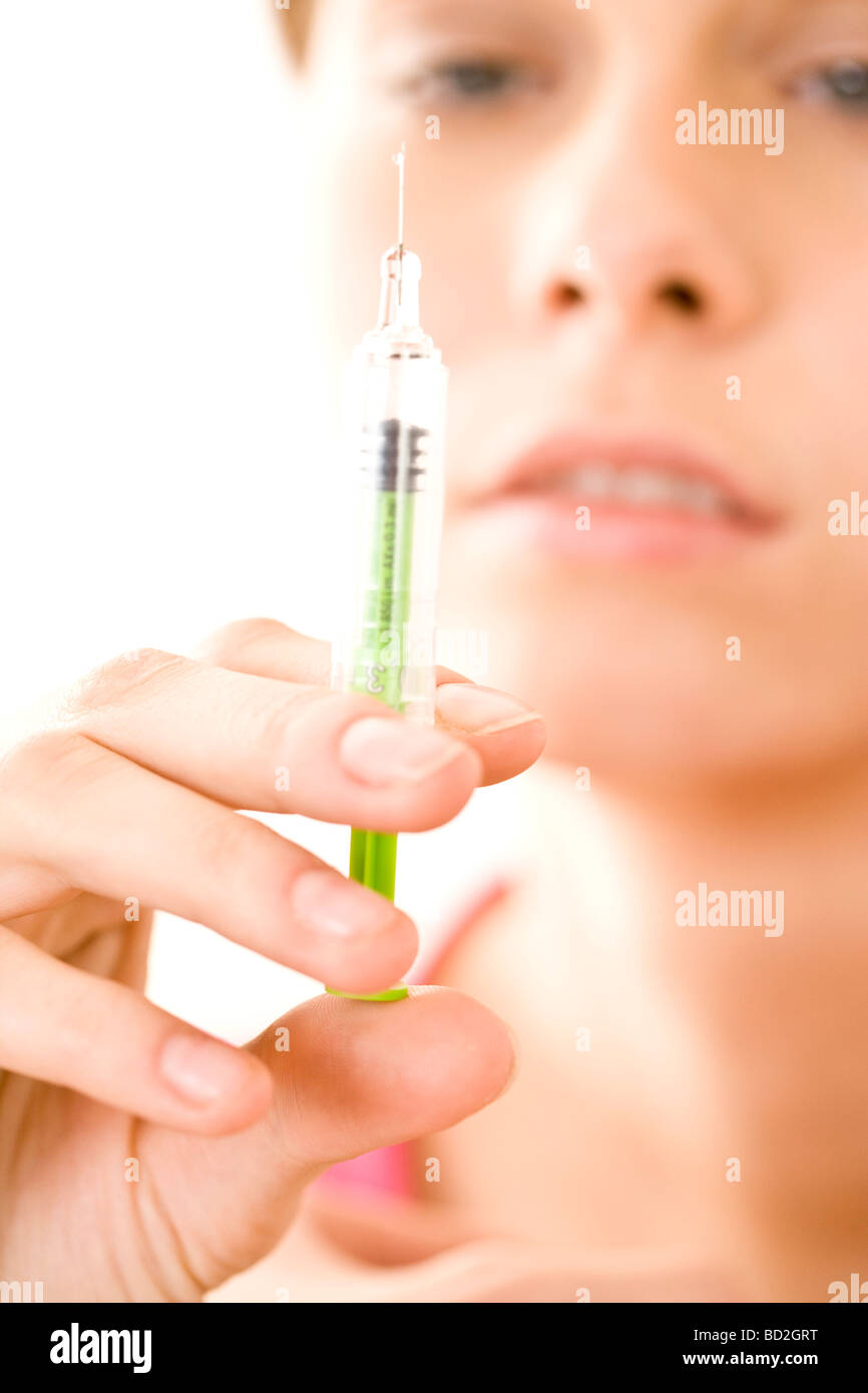 Woman holding syringe Stock Photo - Alamy