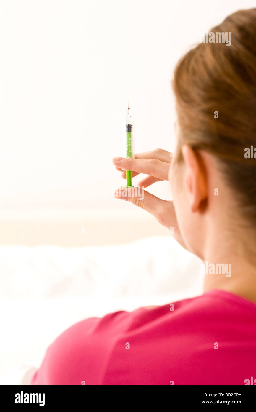 Woman holding syringe Stock Photo - Alamy