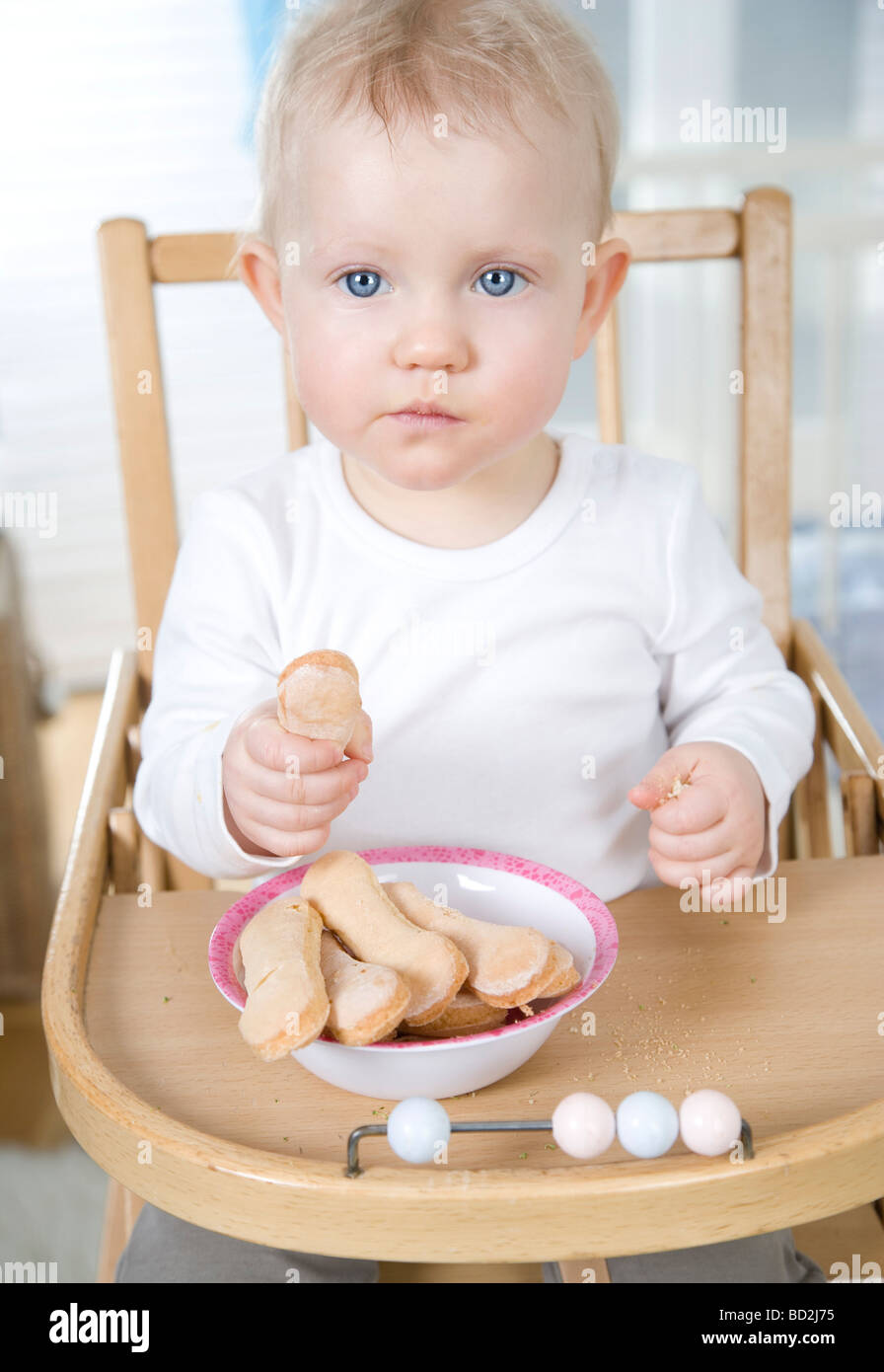 baby girl eating cookies Stock Photo - Alamy
