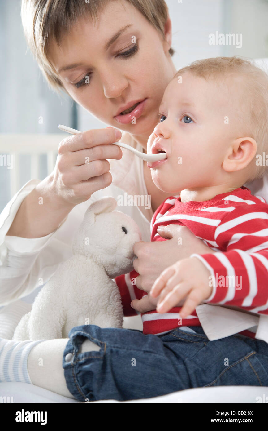 mum giving medicine Stock Photo - Alamy