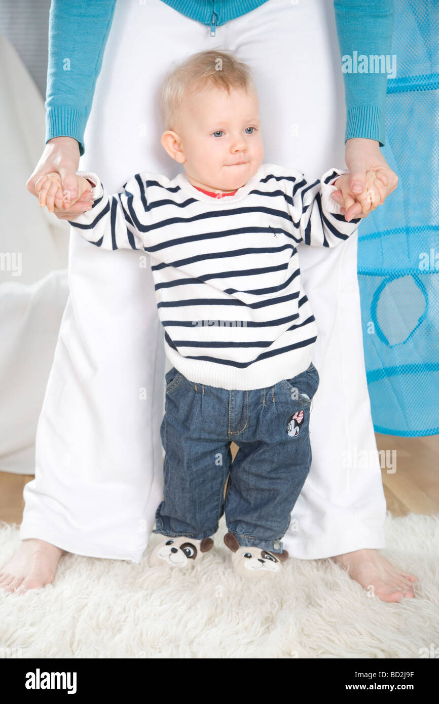 mum learning baby girl walking Stock Photo - Alamy