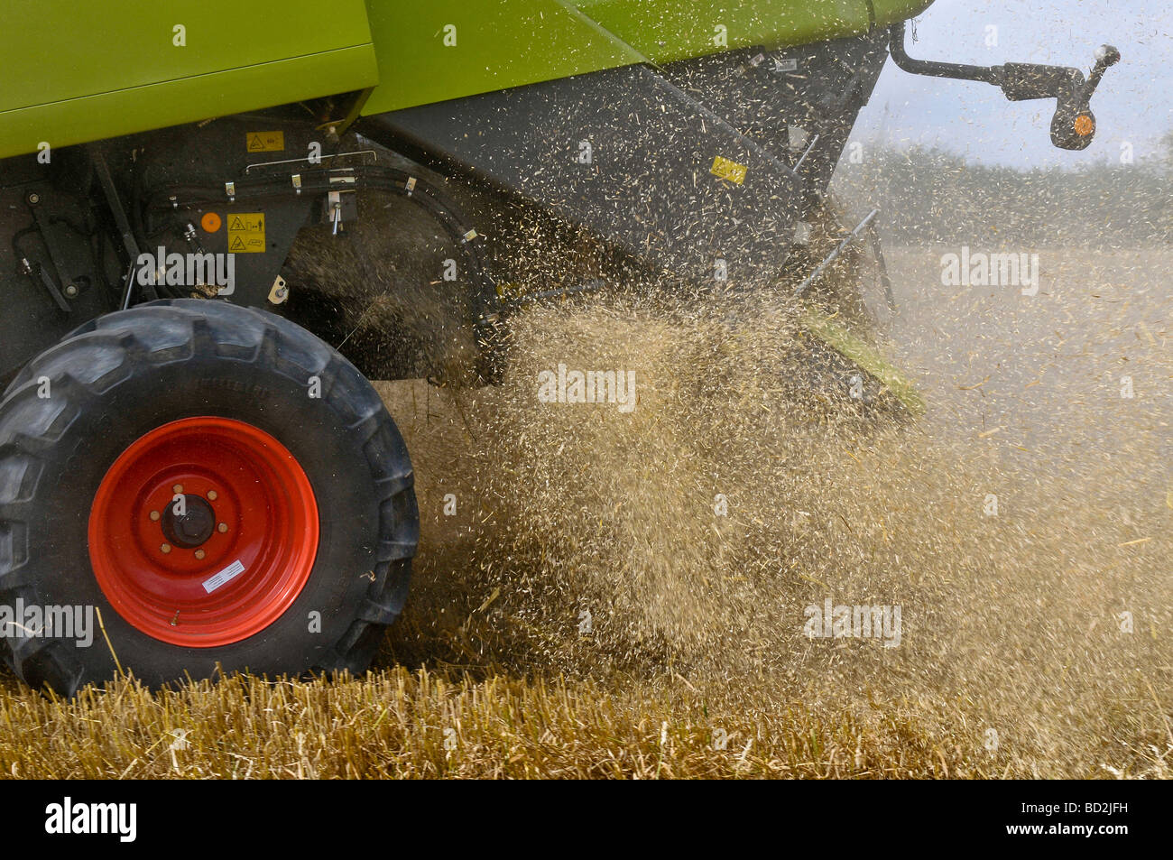 Combine machine chopping straw Stock Photo - Alamy