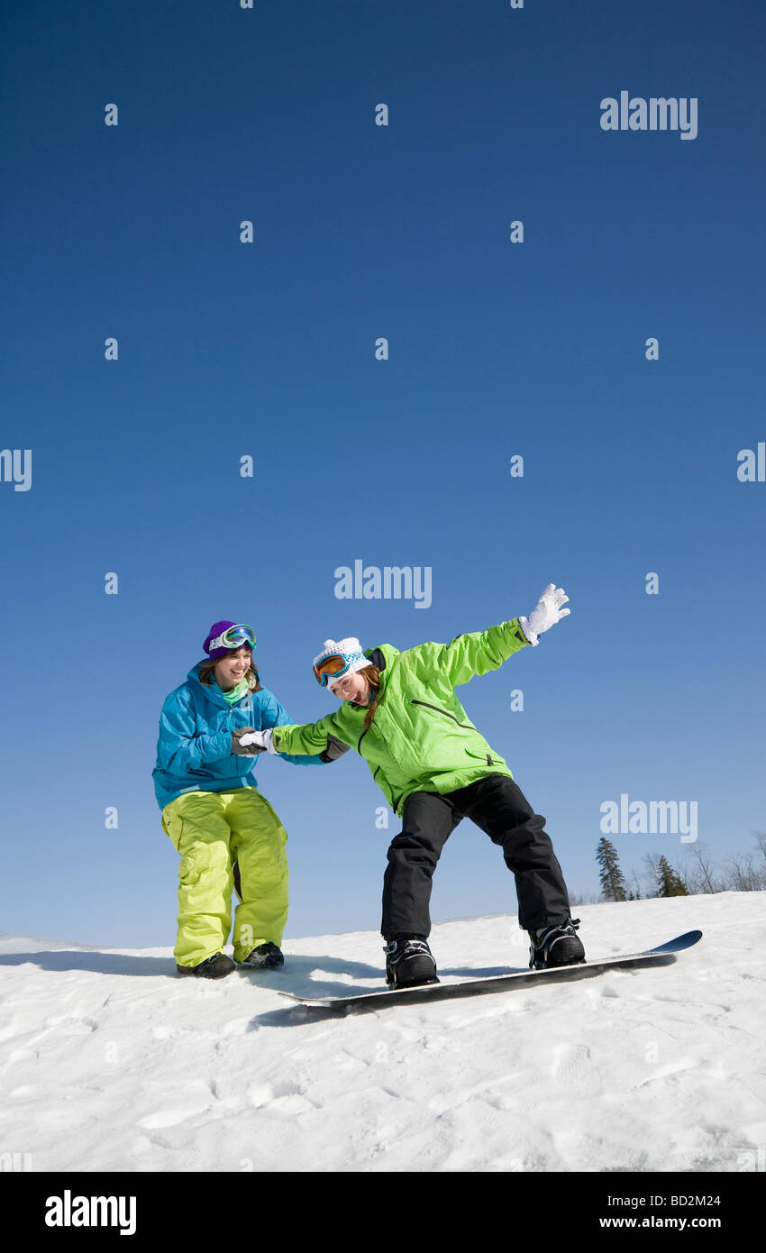 Woman Learning to Snowboard Stock Photo - Alamy