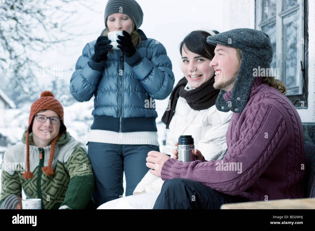 Group of young people drinking warm tea Stock Photo - Alamy