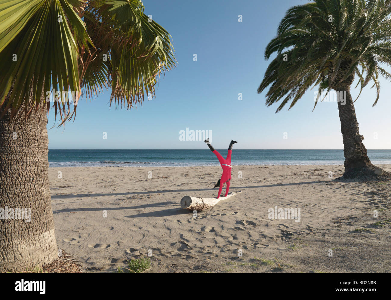 Woman performing handstand on beach Stock Photo - Alamy