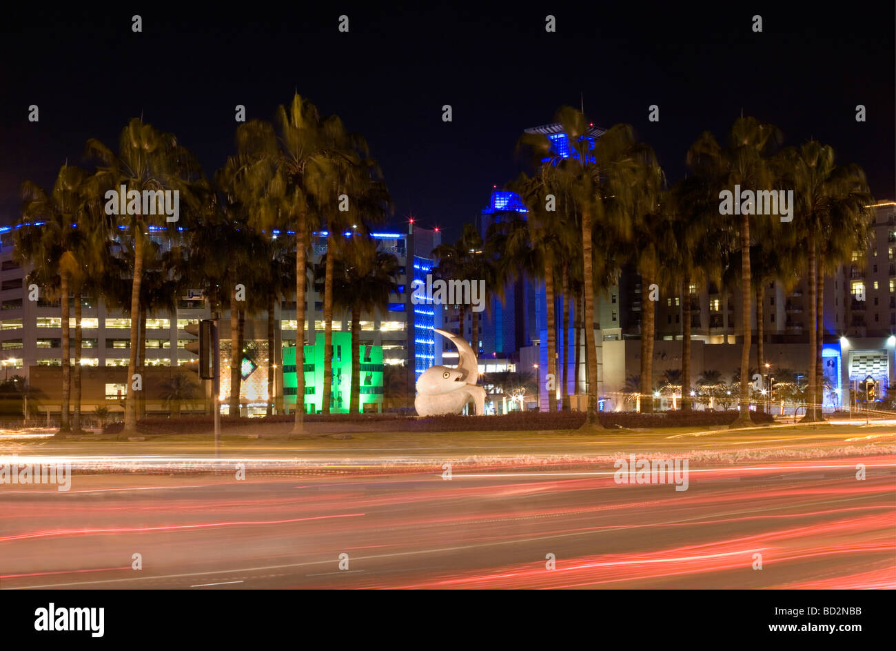 The Fish Roundabout at night with red traffic light trails and streaks ...
