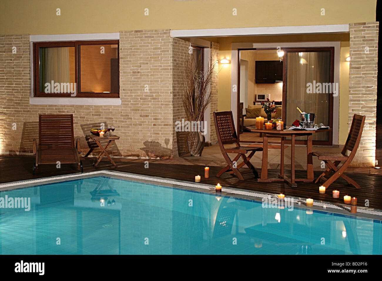 Romantic setting outside a vacation villa beside the swimming pool ...