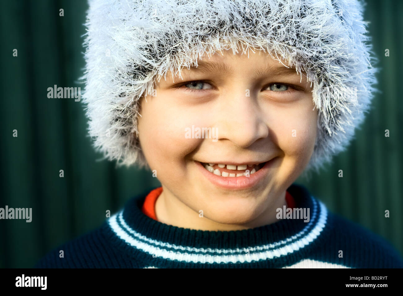Portrait of smiling kid with a winter hat on his head Stock Photo - Alamy