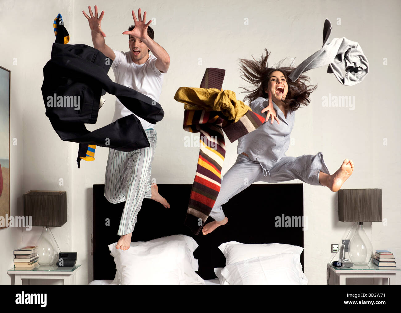 couple jumping and grabbing clothes Stock Photo - Alamy