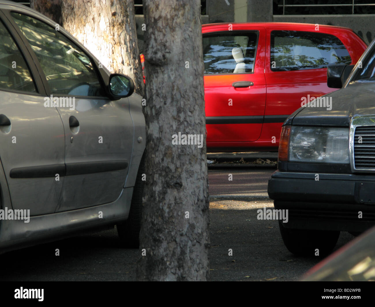 one red car in street in city town Stock Photo - Alamy