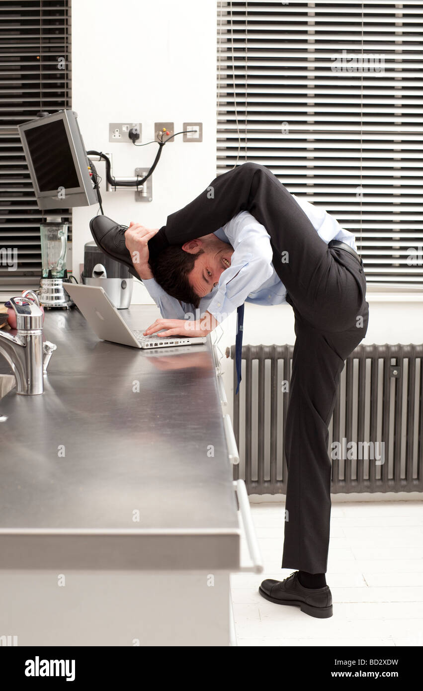 businessman stretching in the kitchen Stock Photo - Alamy