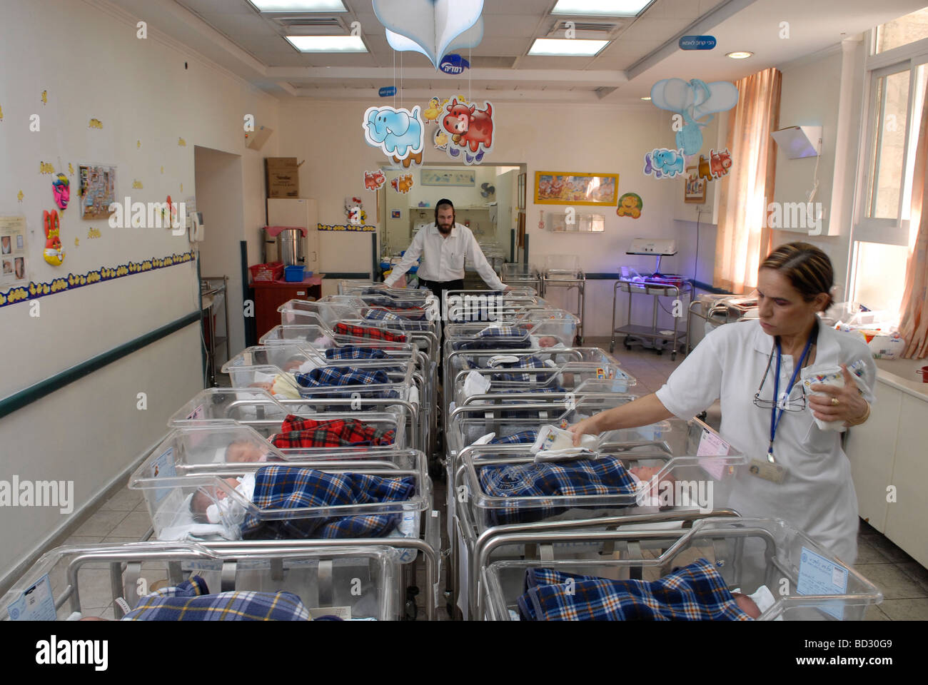 A Haredi Jew stands amid newborn babies at the maternity ward of Bikur ...