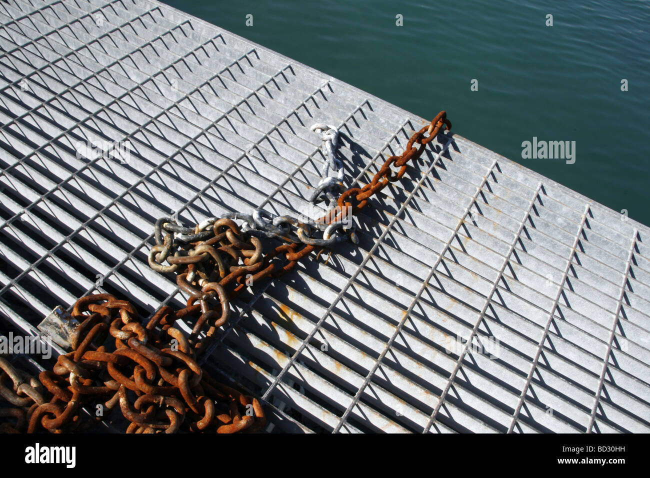 old rusty chain on metal pier in harbour by sea Stock Photo - Alamy