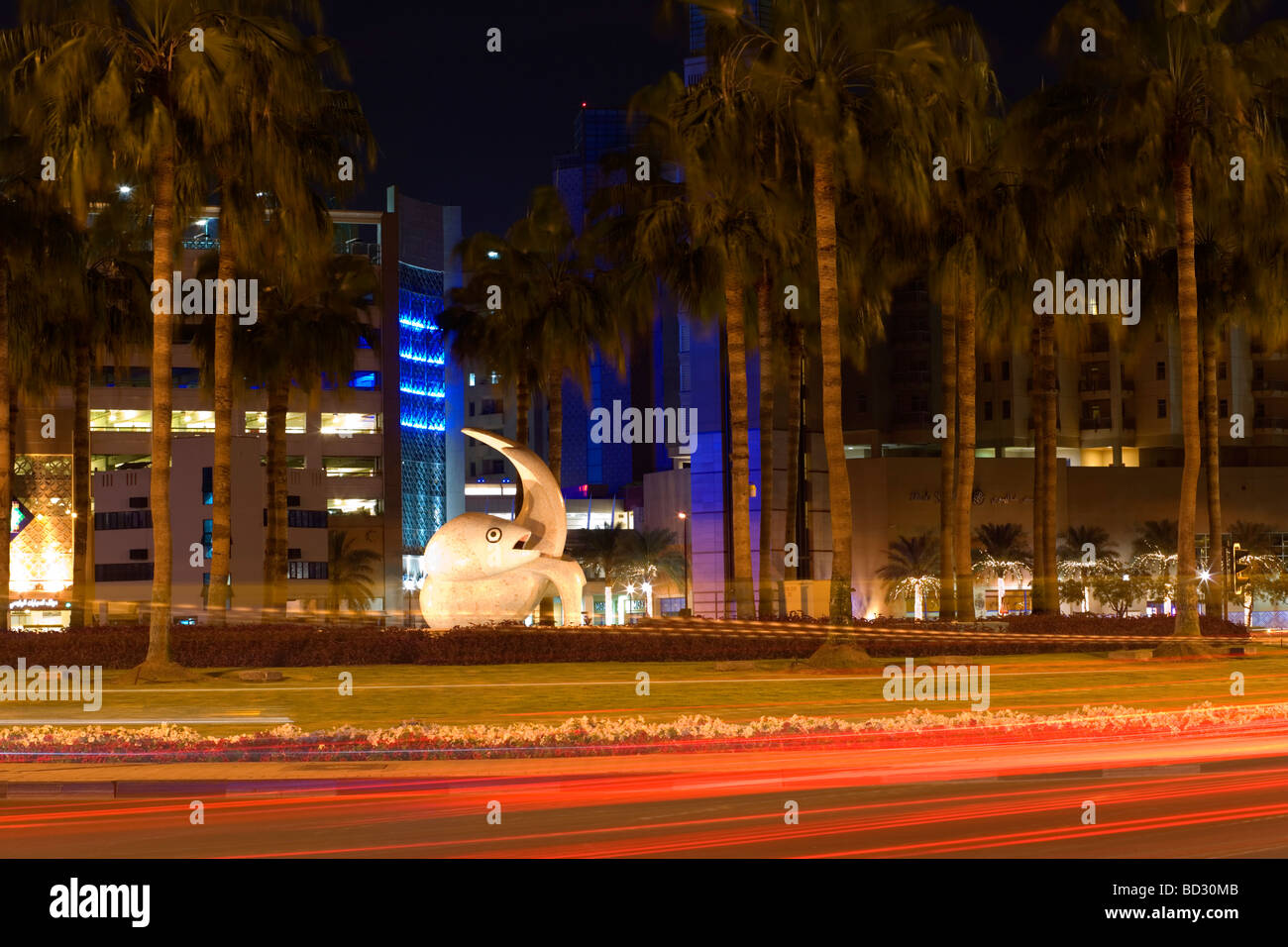 The Fish Roundabout at night with red traffic light trails and streaks ...