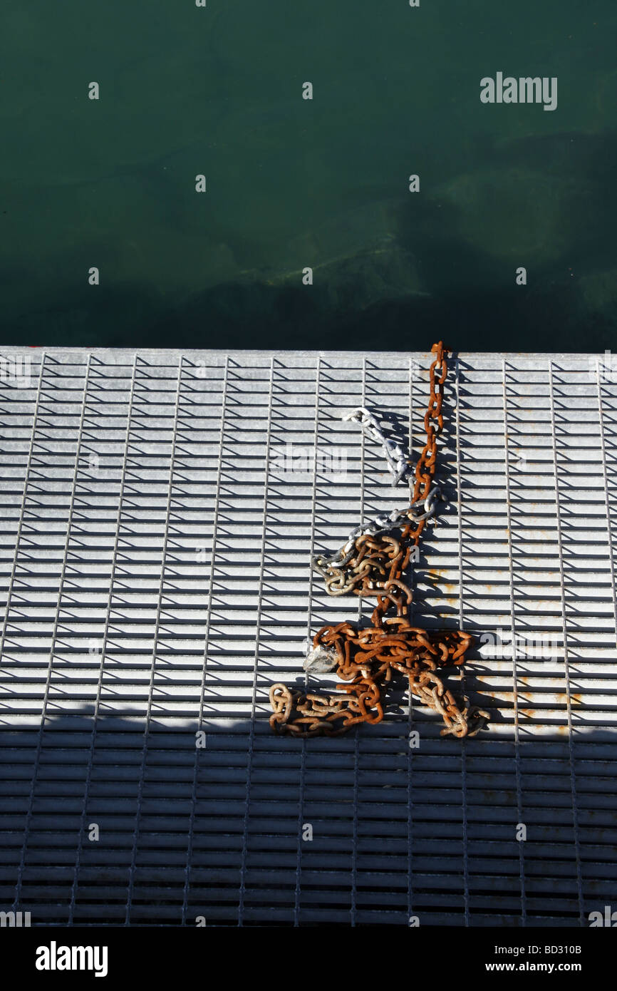 old rusty chain on metal pier in harbour by sea Stock Photo - Alamy