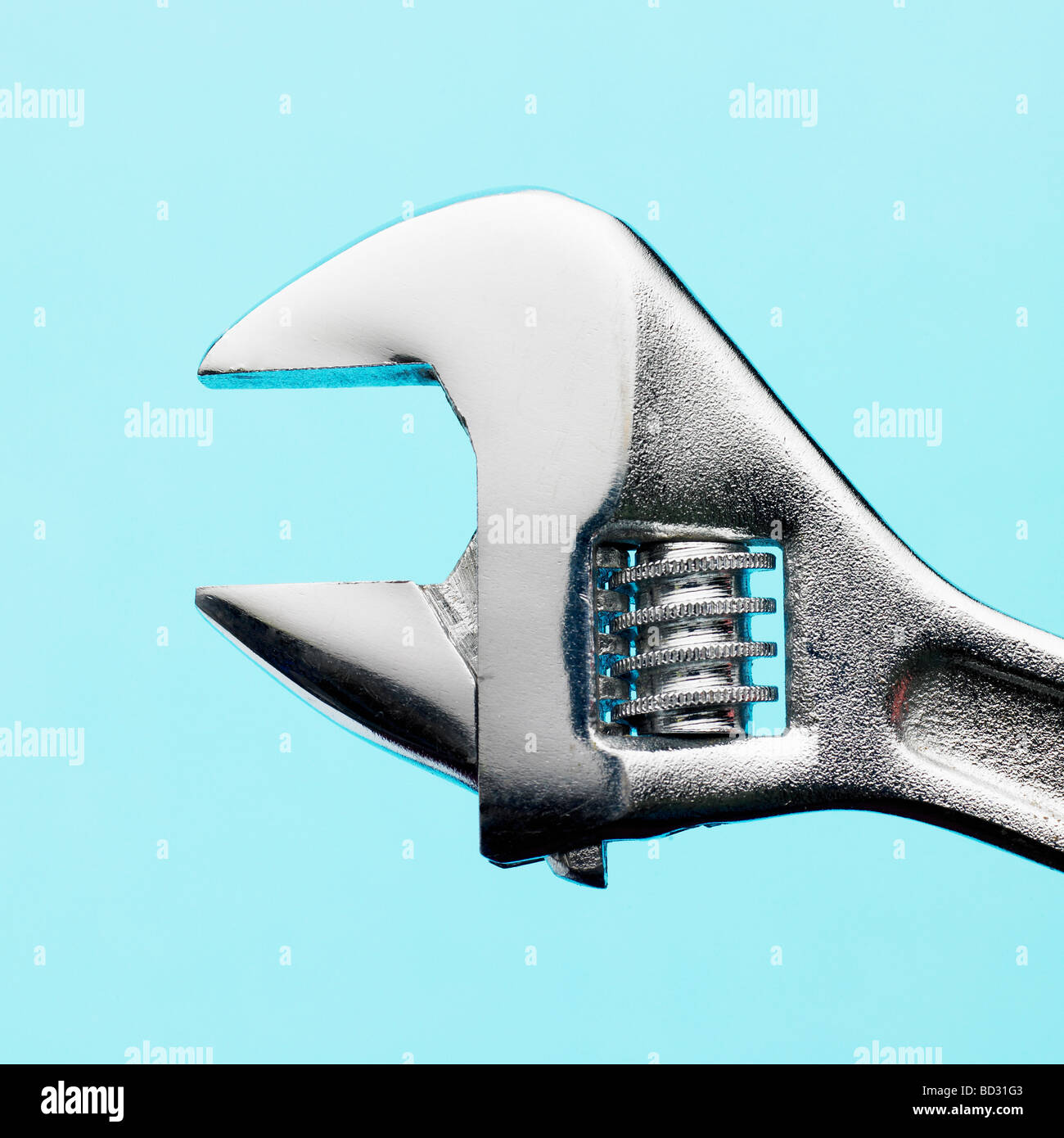 Adjustable chrome spanner on blue background Stock Photo - Alamy