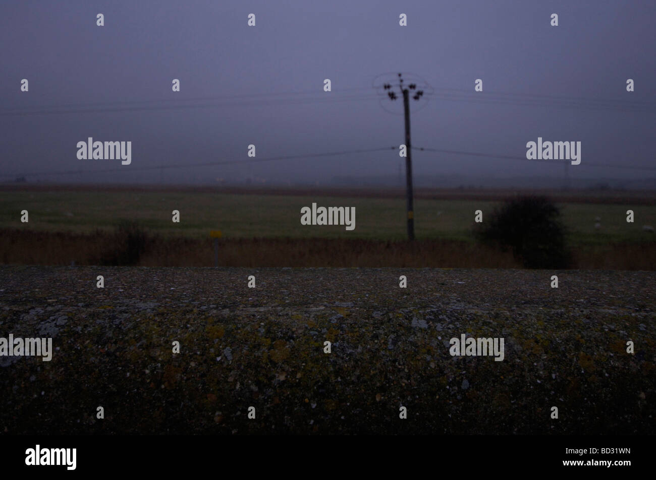 Dark and moody landscape with wall telegraph pole and fields Stock ...