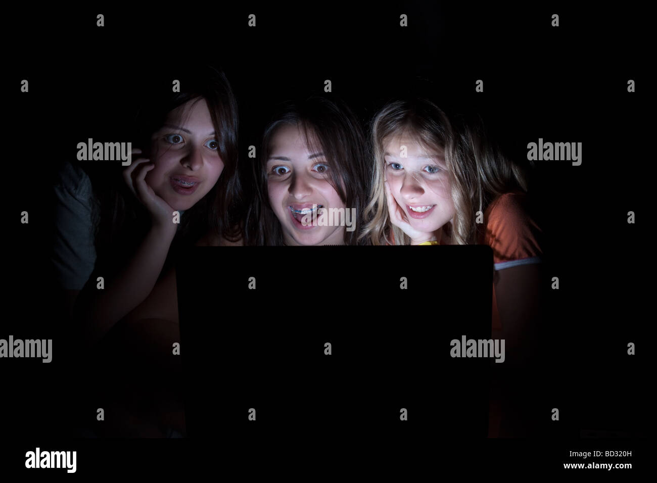 Three girls on the computer at night Stock Photo - Alamy