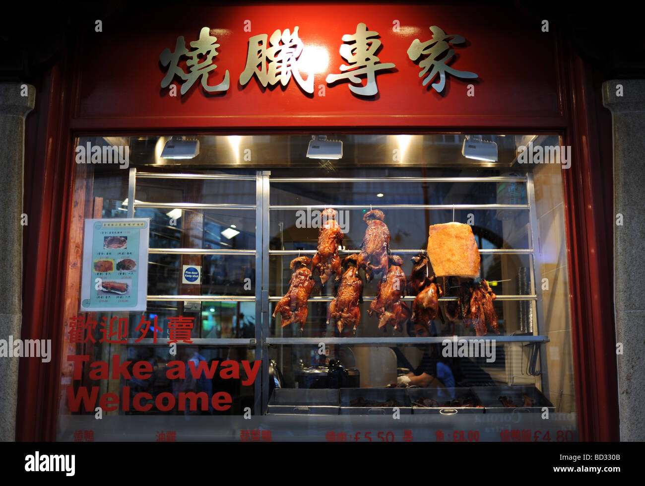 Chef working in the window of a Chinese restaurant in the Chinatown ...