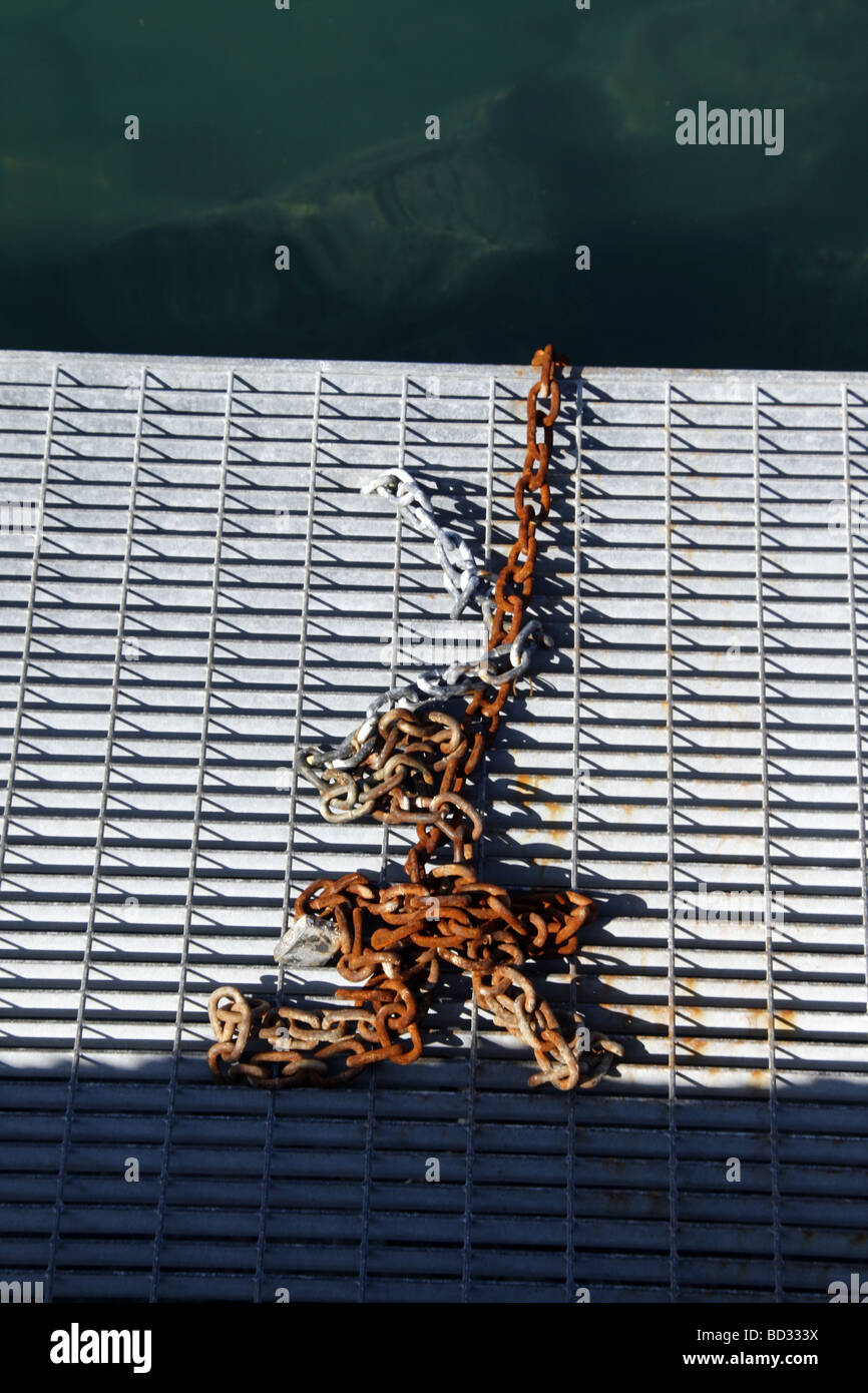 old rusty chain on metal pier in harbour by sea Stock Photo - Alamy