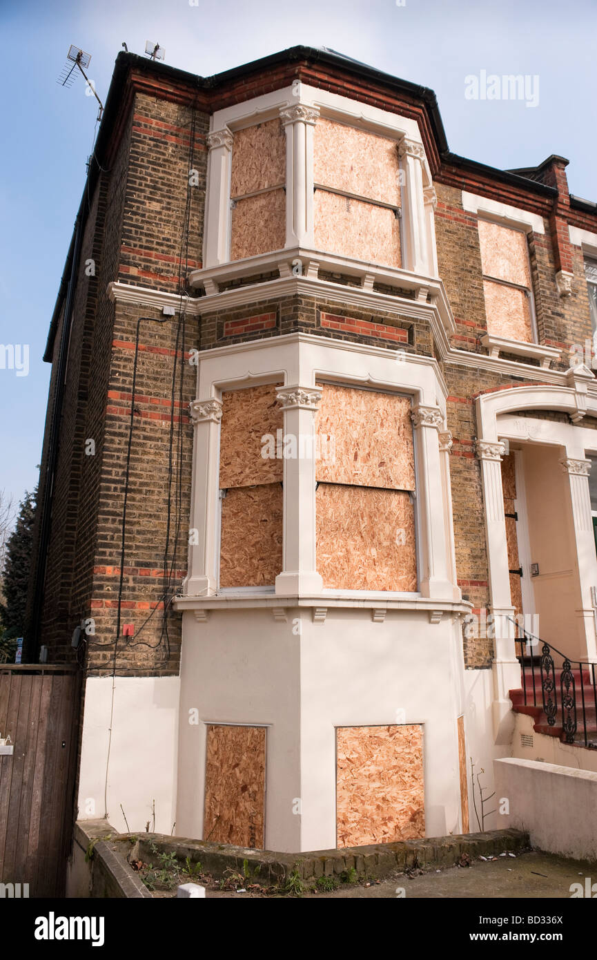Boarded up semi-detached house in London Stock Photo - Alamy