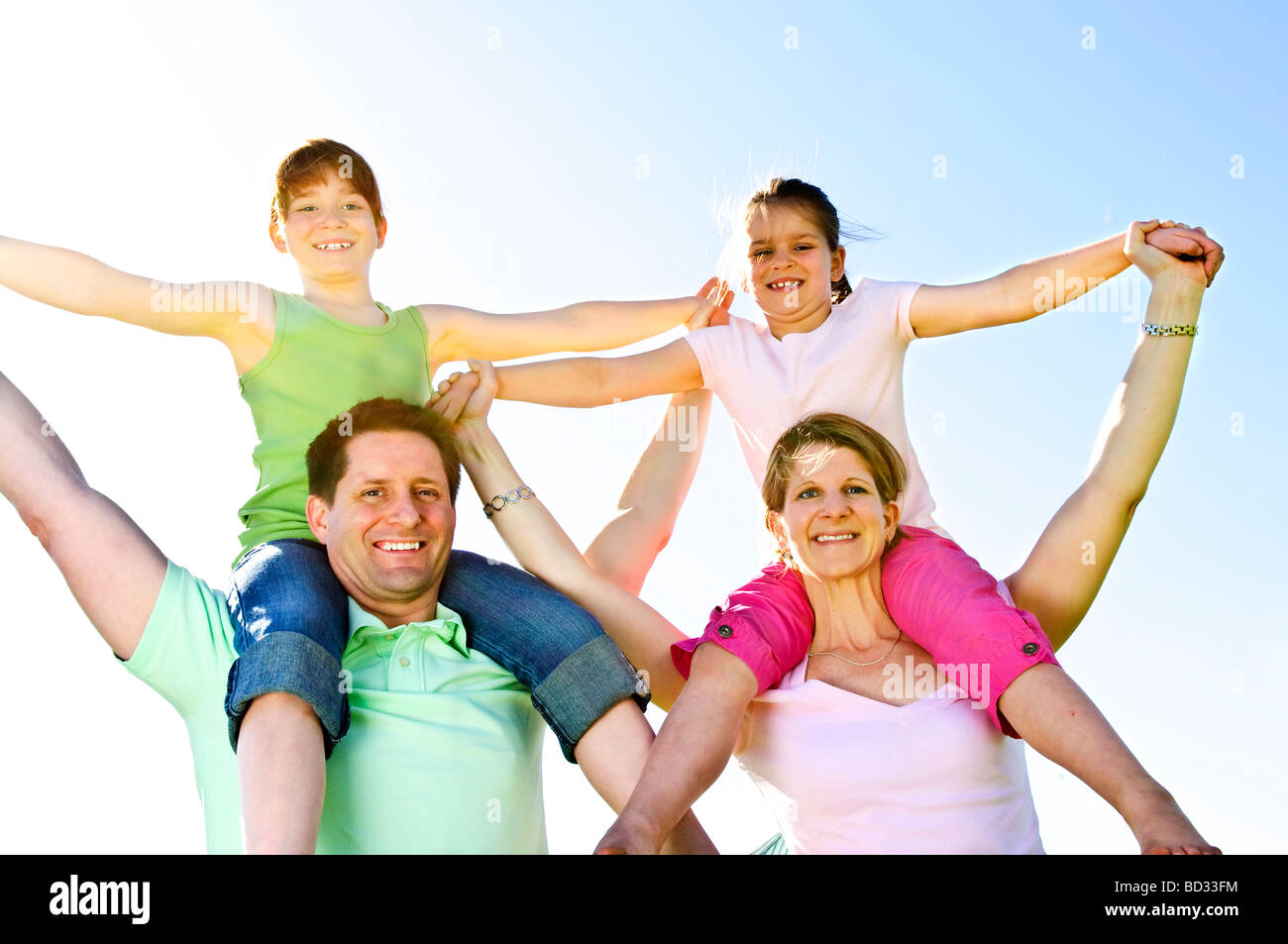 Mother giving daughter shoulder ride hi-res stock photography and ...