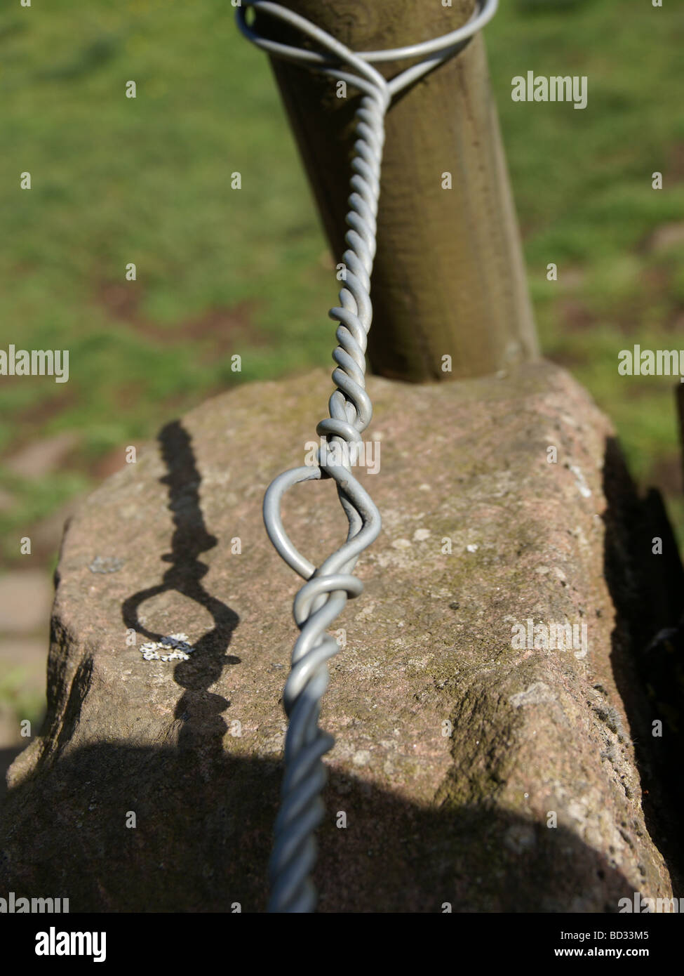 Wire holding post by wall Stock Photo - Alamy