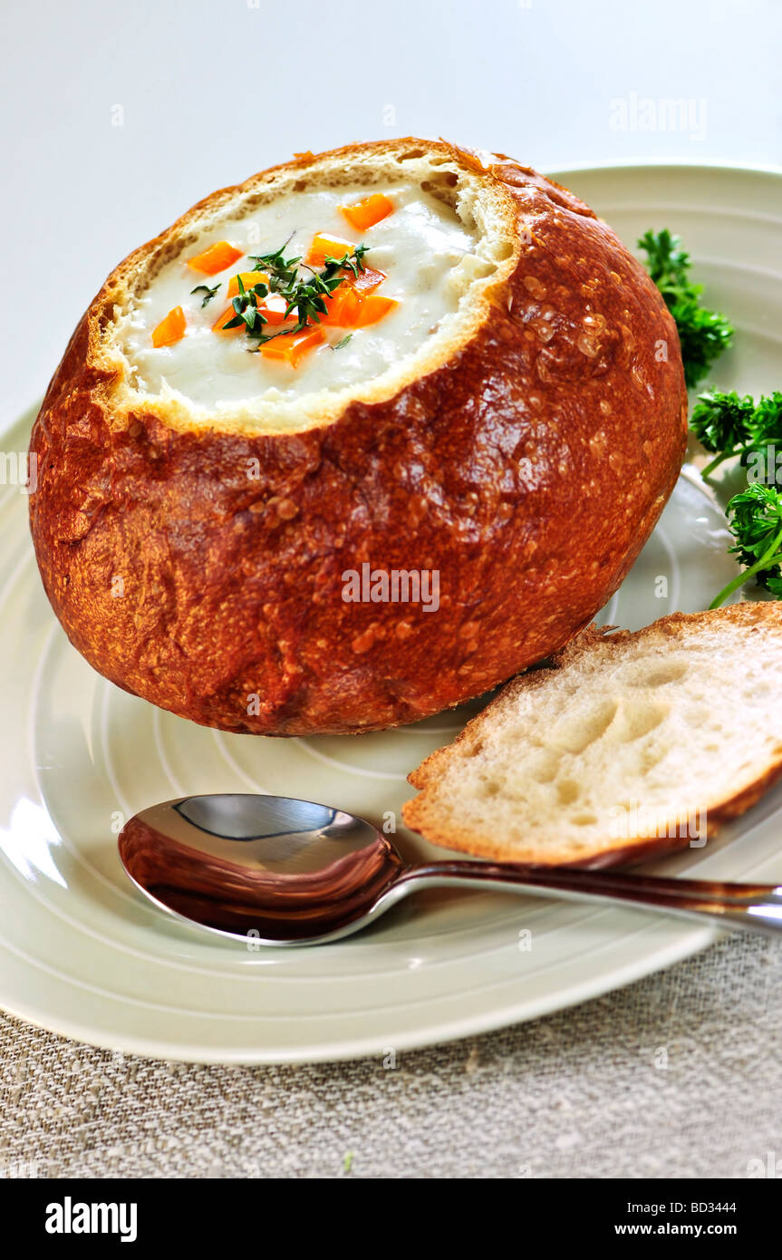 Lunch of soup served in baked round bread bowl Stock Photo - Alamy