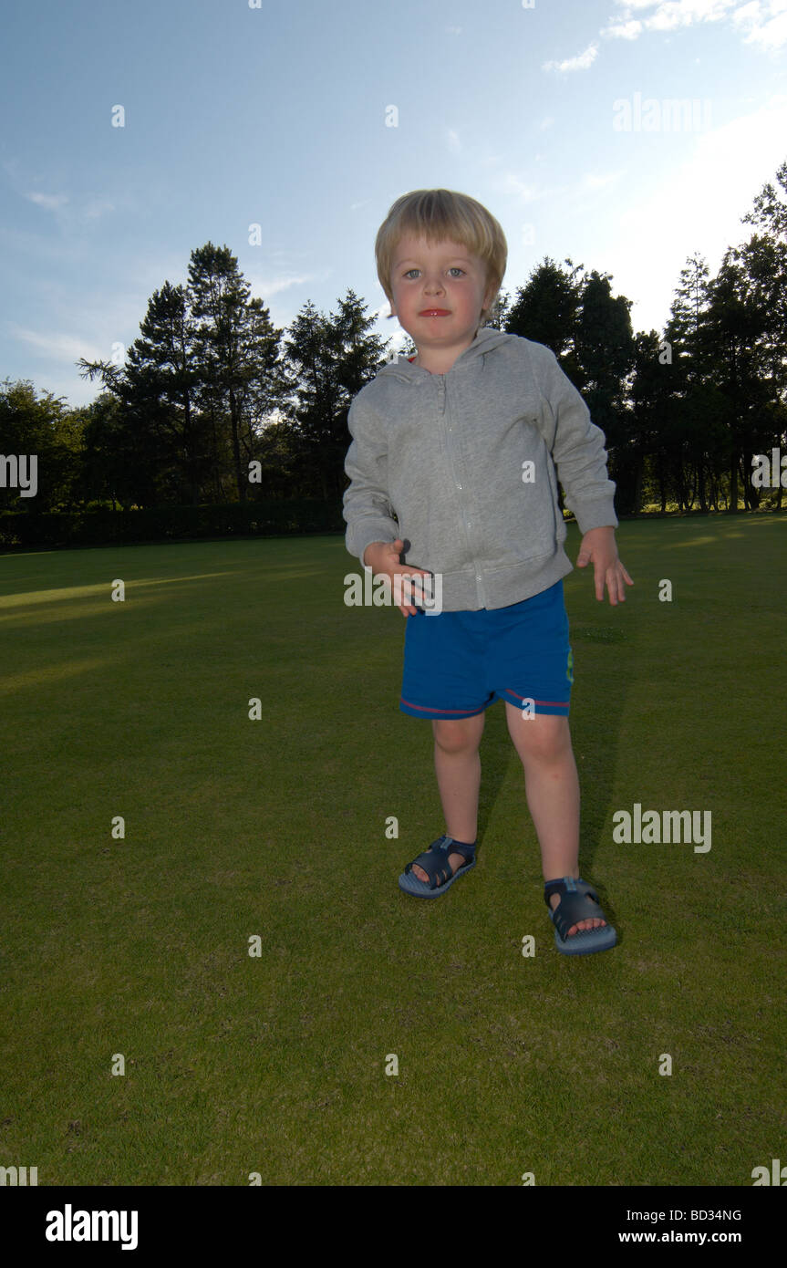 Boy child playing in park Stock Photo - Alamy