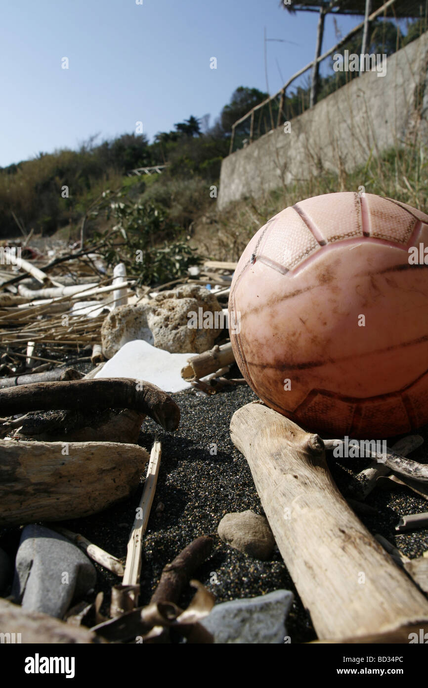 one football and debris washed up on sea shore Stock Photo - Alamy