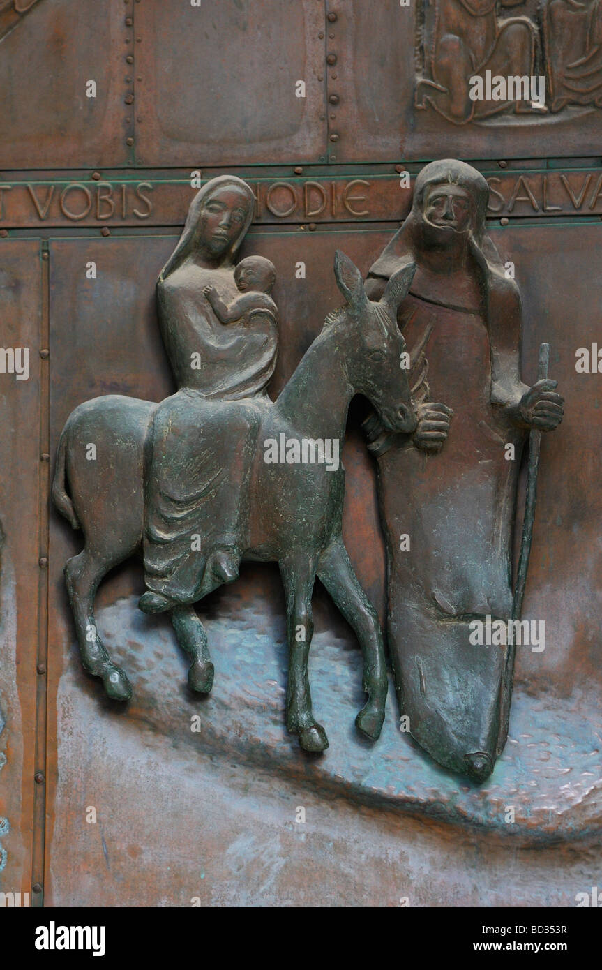 A carved door depicting Joseph and Mary with baby Jesus riding a donkey ...