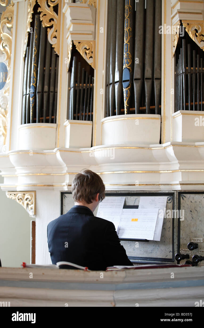 organist playing the pipe organ in the church Weltewitz, Saxony; the ...
