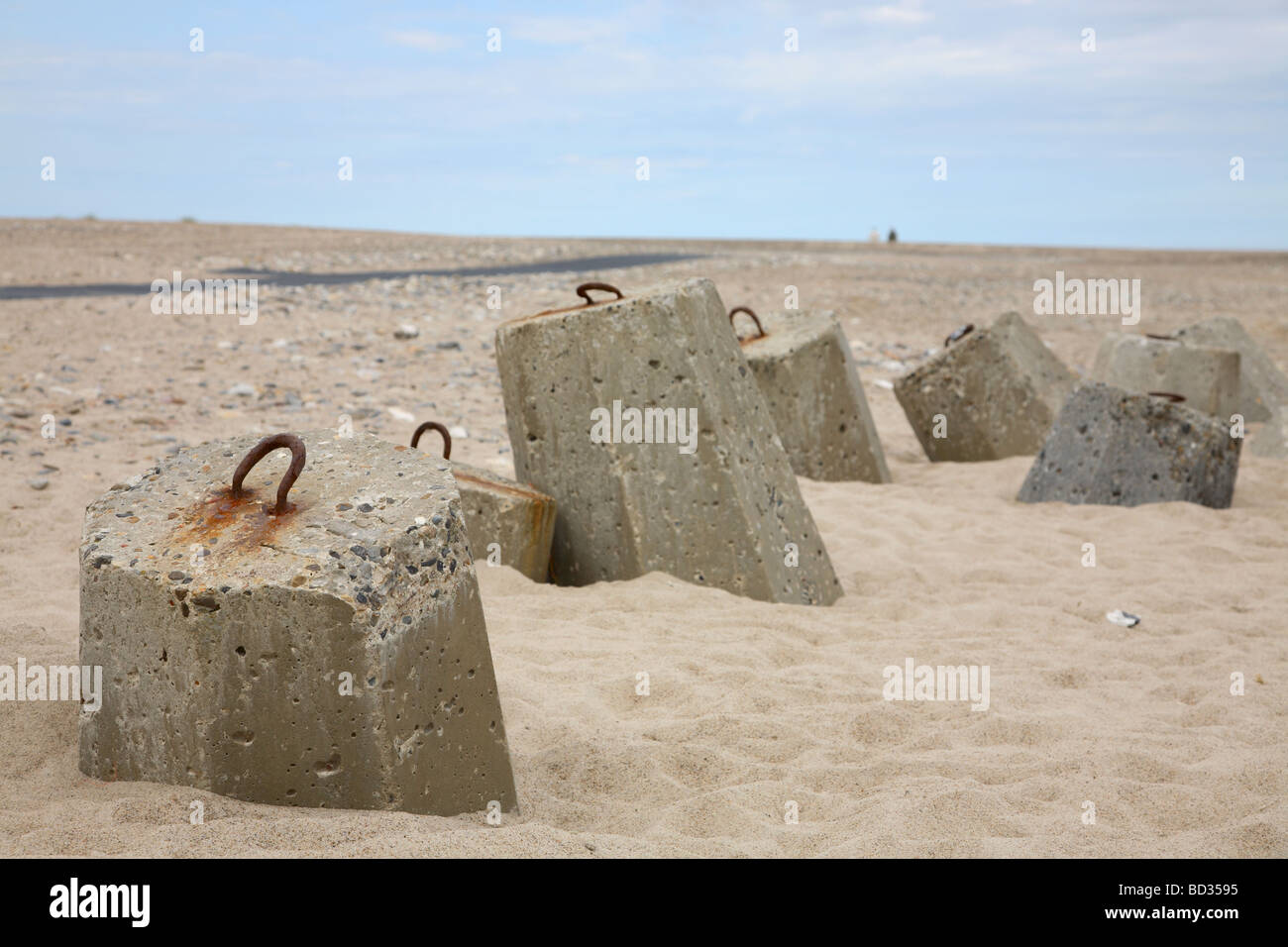 Octagonal concrete anchors with rusty iron rings strewn artistically on ...