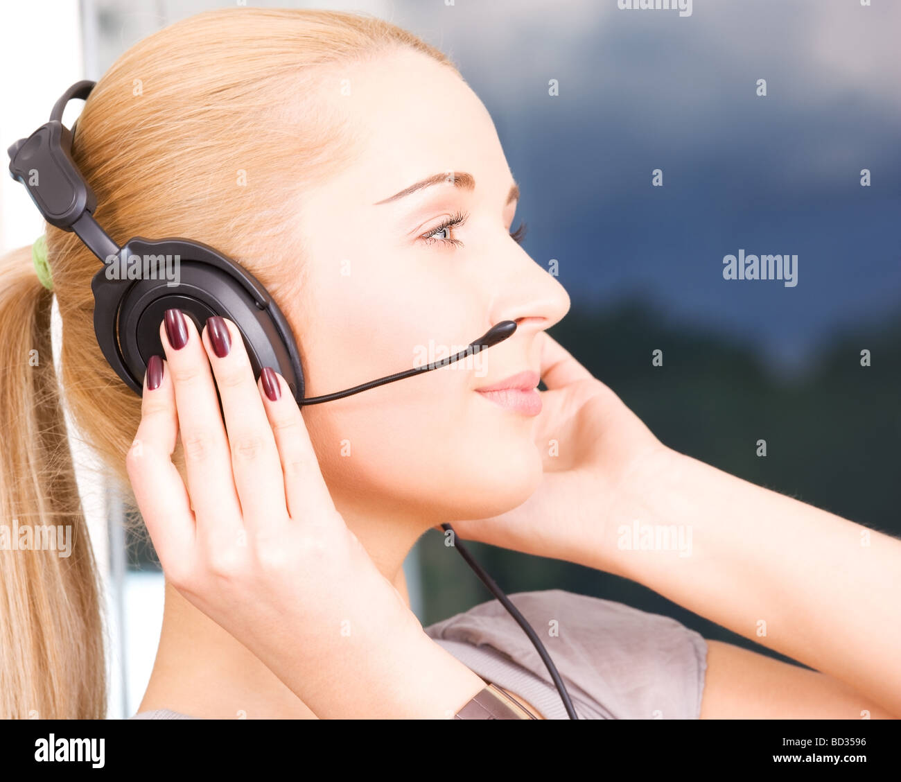 bright picture of friendly female helpline operator Stock Photo - Alamy