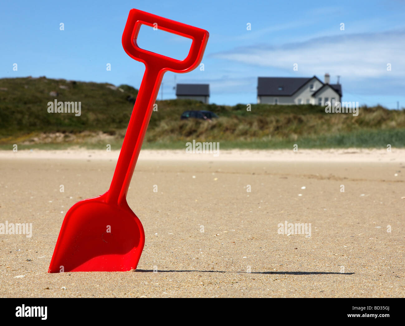Red Plastic Spade on Holiday Beach Stock Photo - Alamy