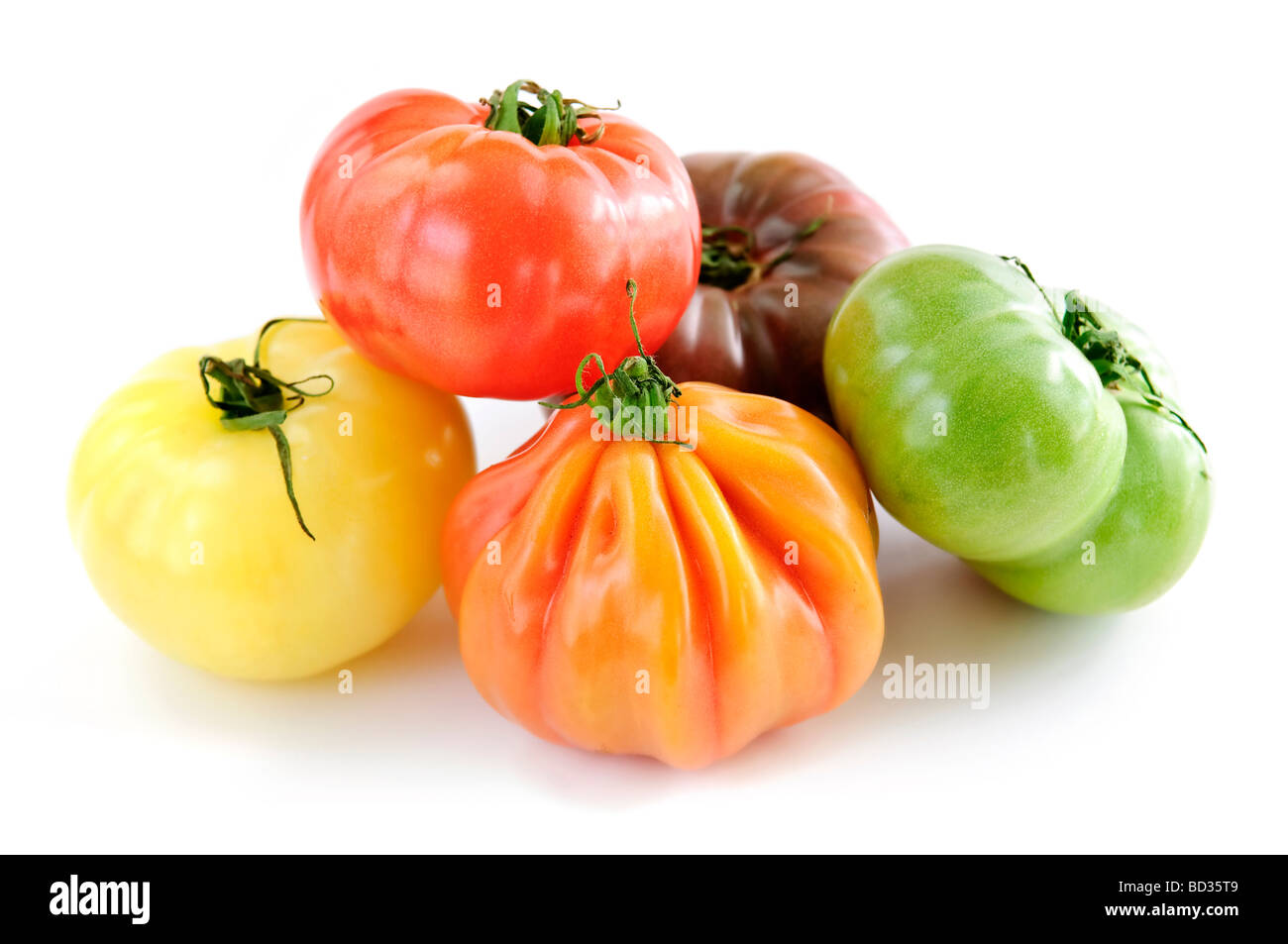 Multi colored heirloom tomatoes isolated on white background Stock ...
