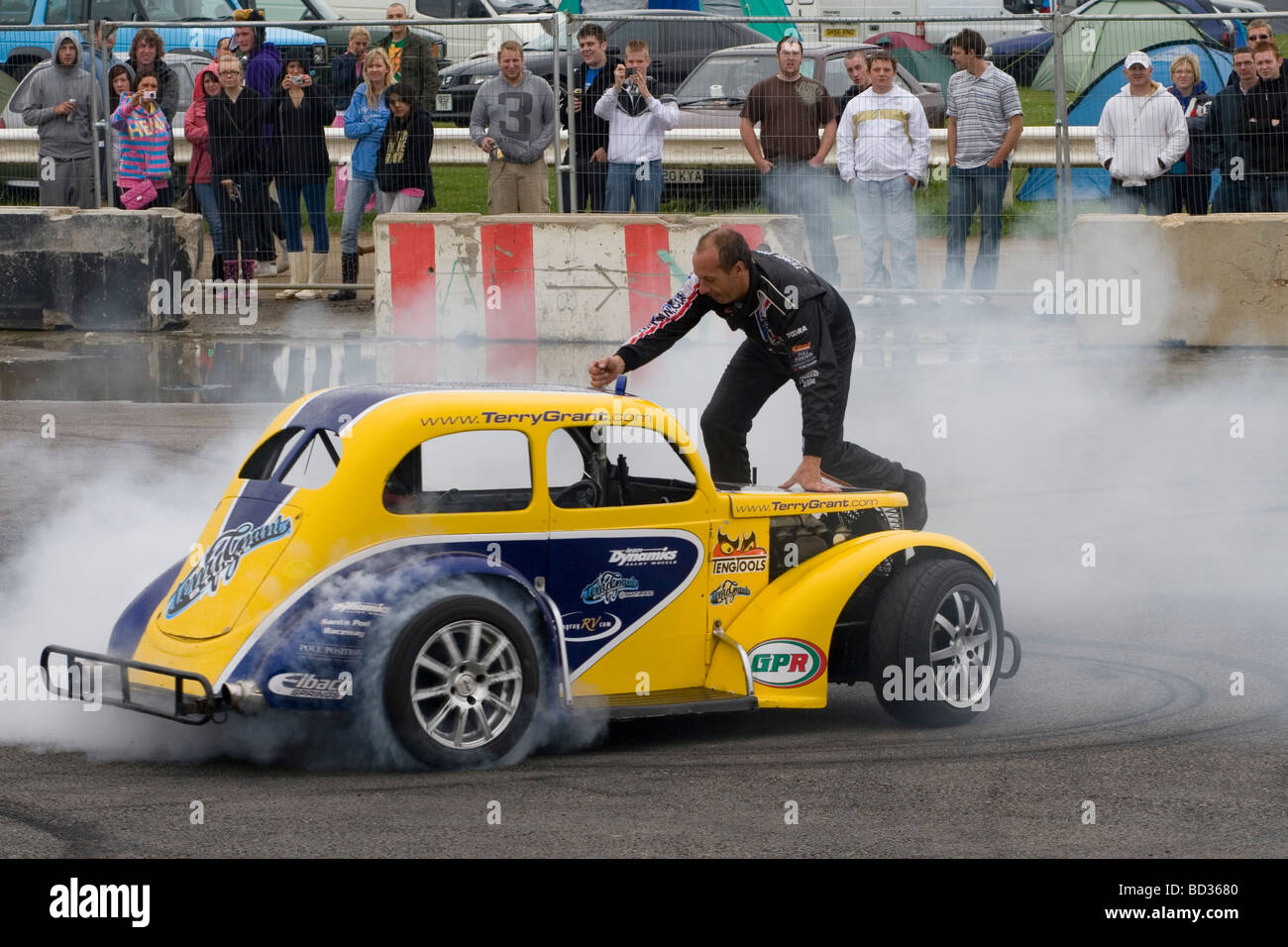 Terry Grant stuntman climbs out of his car whilst performing a stunt as ...