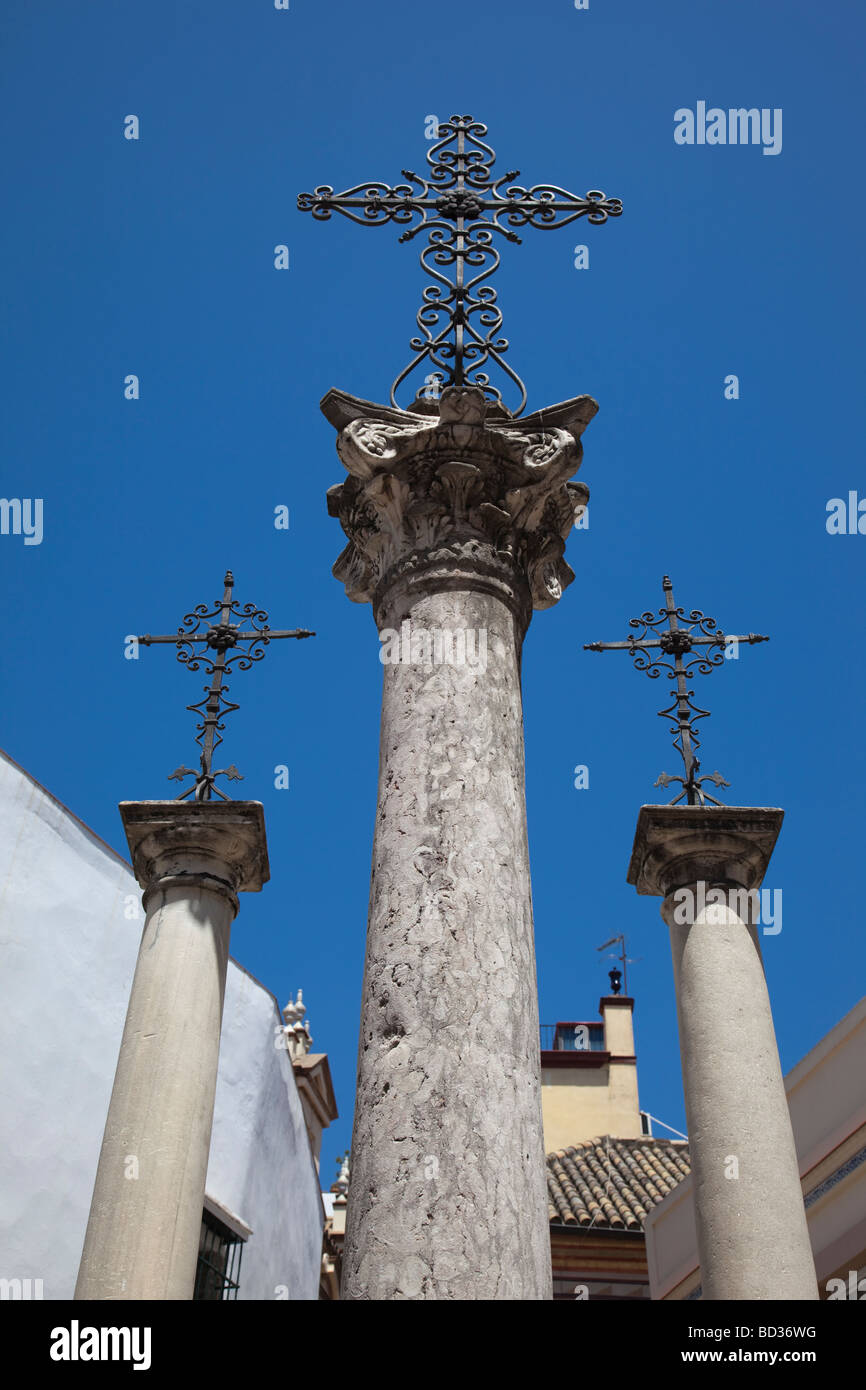 Three ornate metal crosses on columns in Santa Cruz square, Seville ...