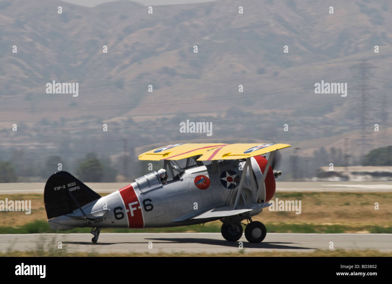 A Grumman F3F-2 biplane taxis on the runway at an airshow Stock Photo ...