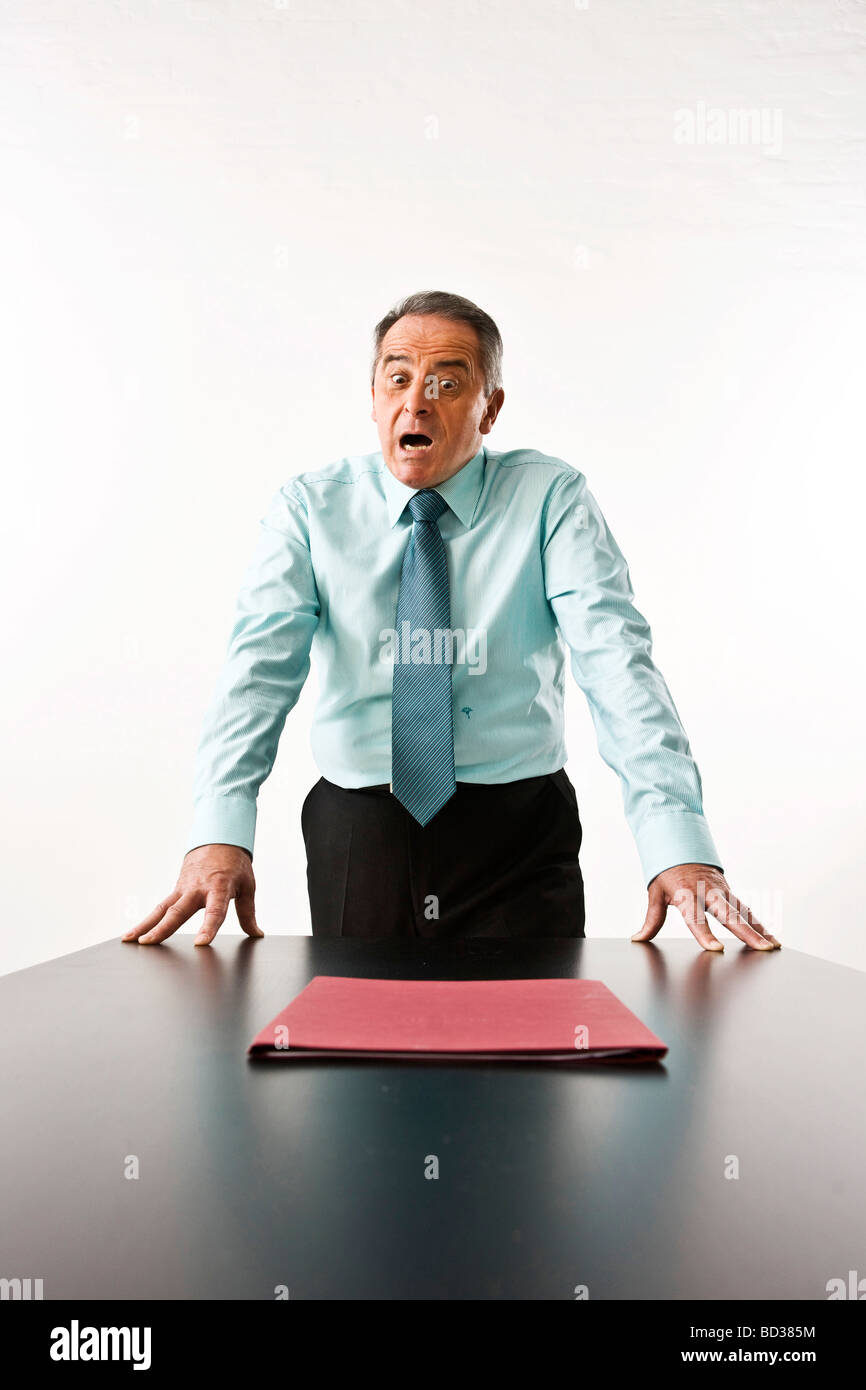 Manager leaning on his desk Stock Photo - Alamy