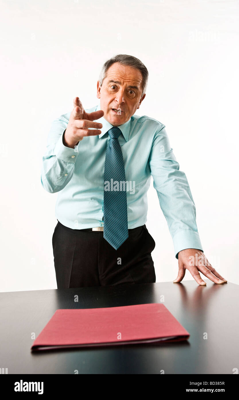 Manager leaning on his desk Stock Photo - Alamy