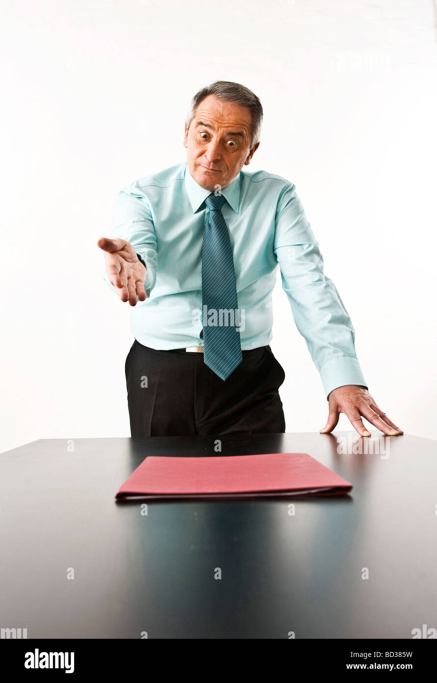 Manager leaning on his desk Stock Photo - Alamy