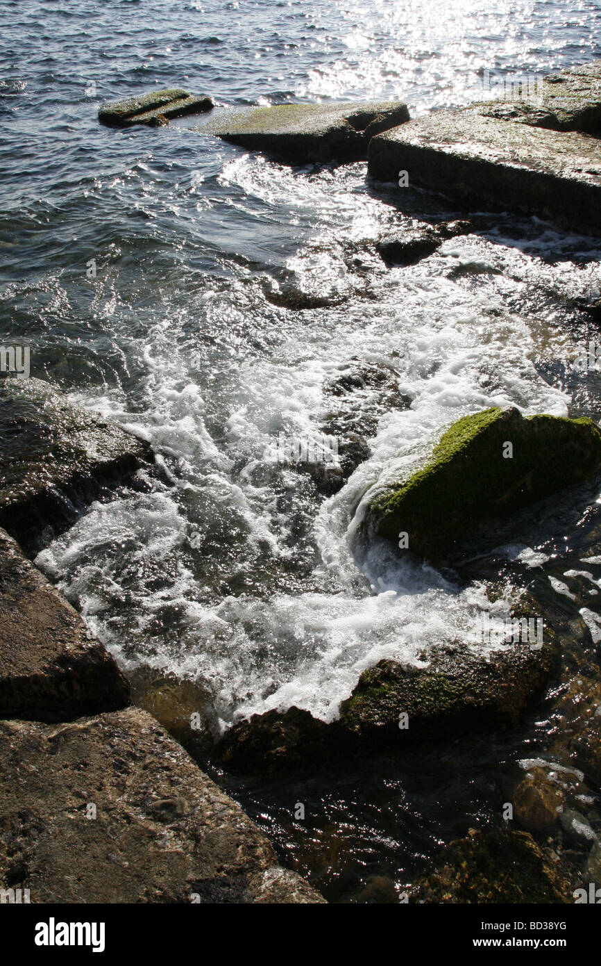 clear blue sea waves breaking onto rocks Stock Photo - Alamy