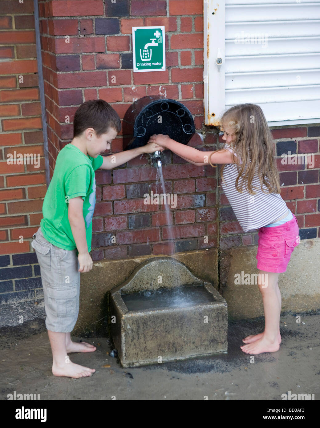 Children Playing with a Water Tap Stock Photo - Alamy