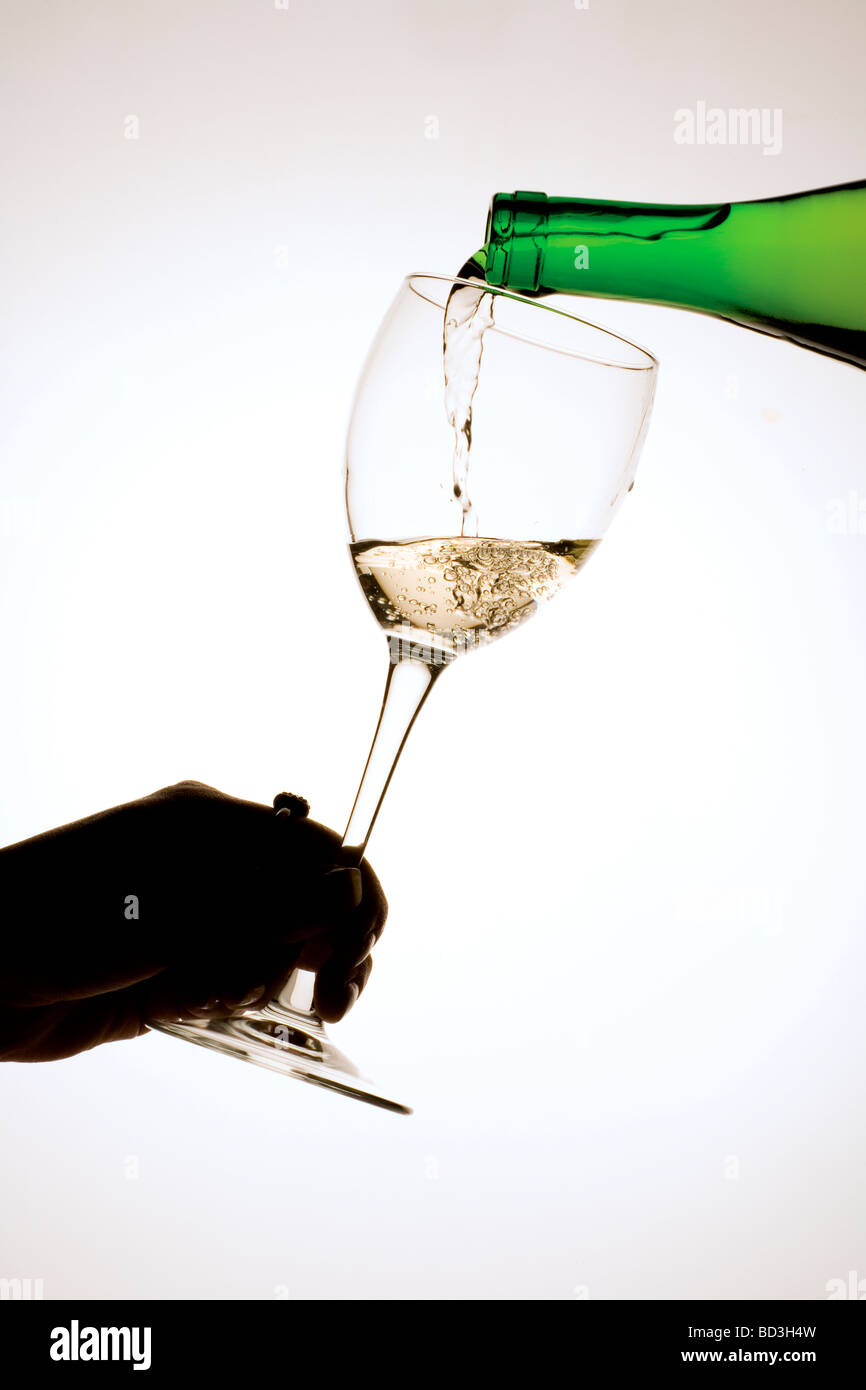 serving white wine in a glass Stock Photo - Alamy