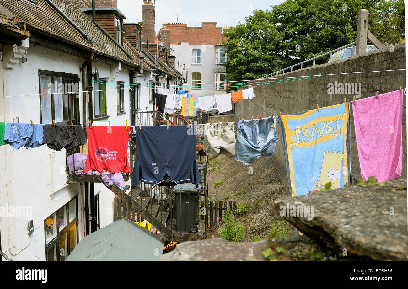 Washing hanging on the line in alley behind terraced houses in ...