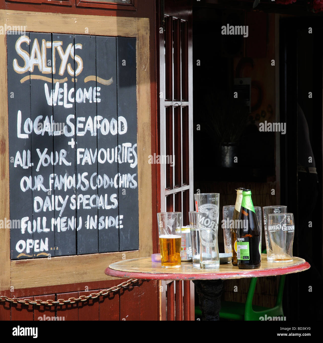Pub glasses on table with menu Stock Photo - Alamy